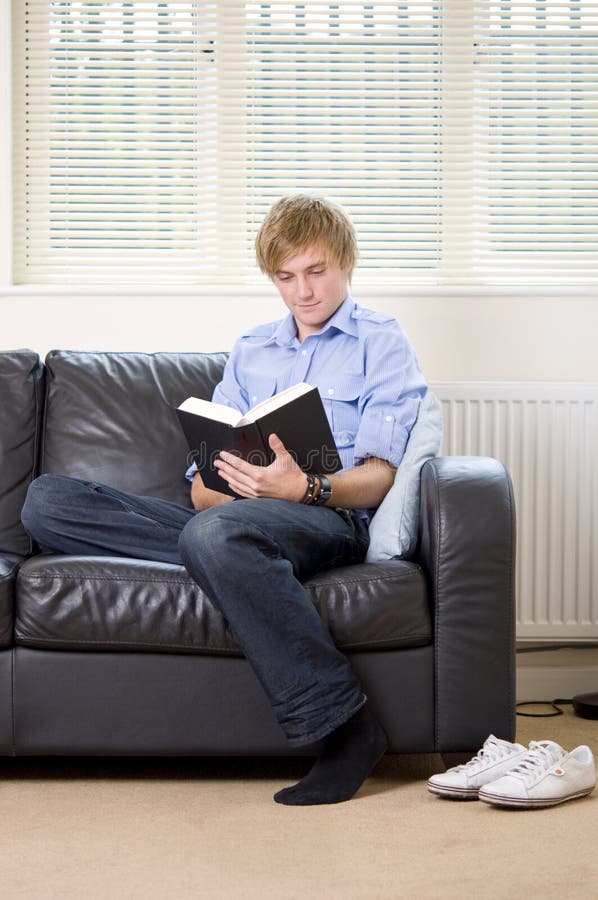 Young Man Sat Sofa Reading Book Stock Photos - Free & Royalty-Free ...