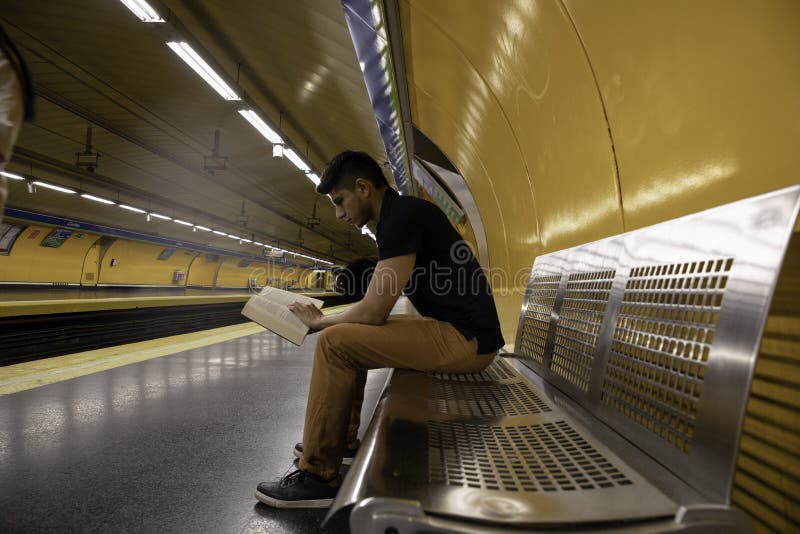 Young Man Reading a Book at the Subway Station Stock Image - Image of ...