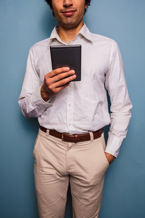 Young Man Reading on a Digital Tablet Stock Image - Image of ...