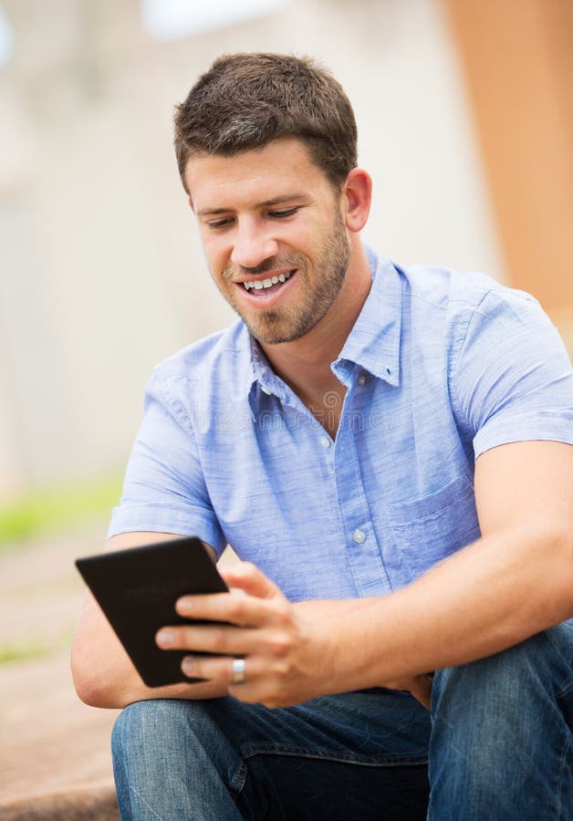 Young Man Reading E-book Outside Stock Photo - Image of greenery ...