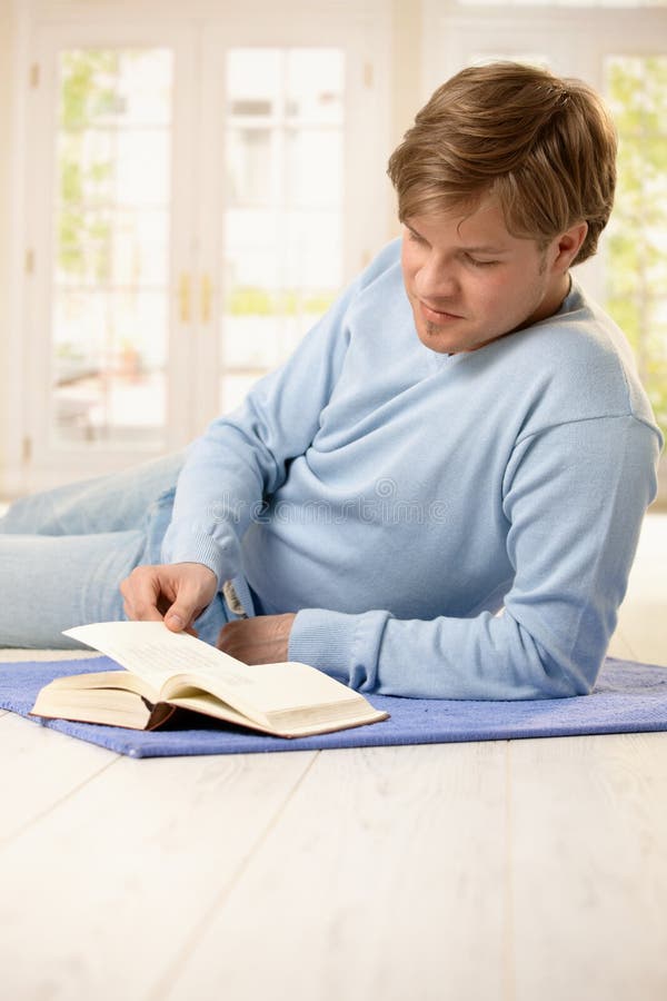 Young man reading at home stock image. Image of lifestyle - 19674235