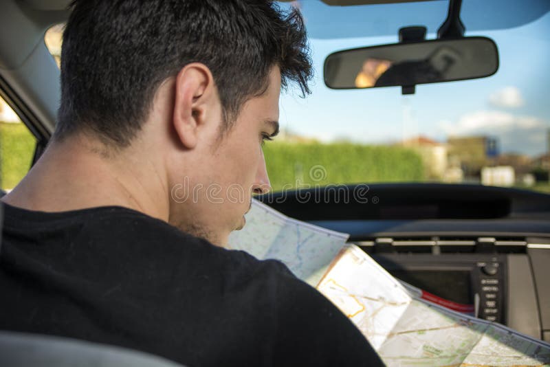 Young Man Reading Map Inside of a Car Stock Image - Image of handsome ...