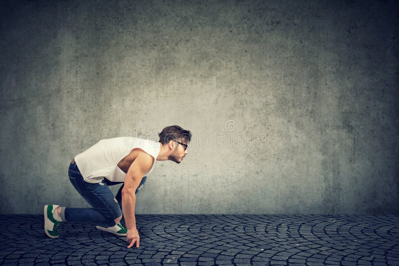 Young Man in Ready Position on Start Line To Compete Stock Photo ...