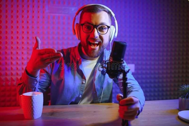 Young Man Recording or Streaming Podcast Using Microphone at His Small ...