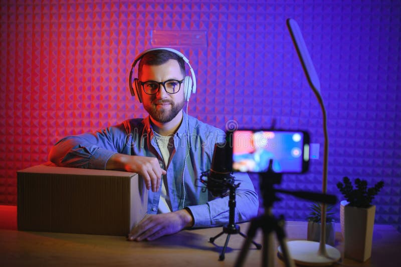 Young Man Recording or Streaming Podcast Using Microphone at His Small ...