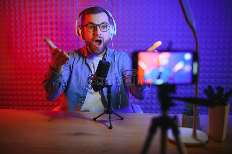 Young Man Recording or Streaming Podcast Using Microphone at His Small ...