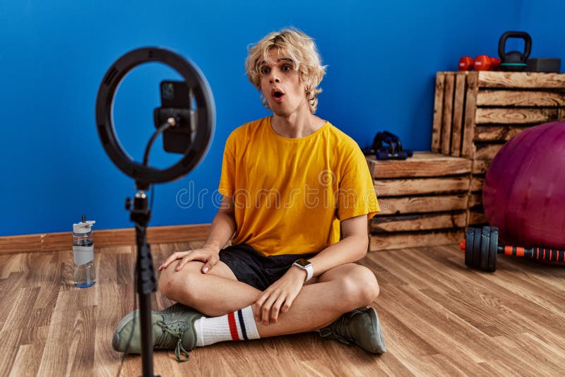 Young Man Recording Training Tutorial at the Gym Scared and Amazed with ...