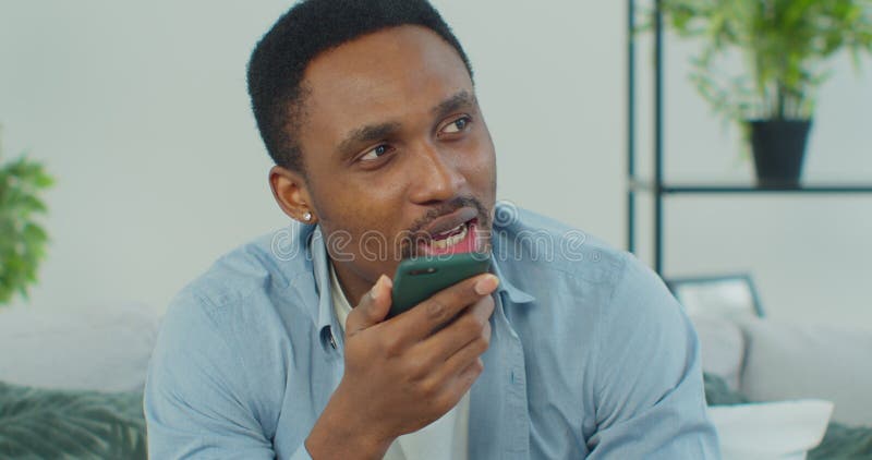 Young Man Recording Voice Recognition Message on Speakerphone. African ...