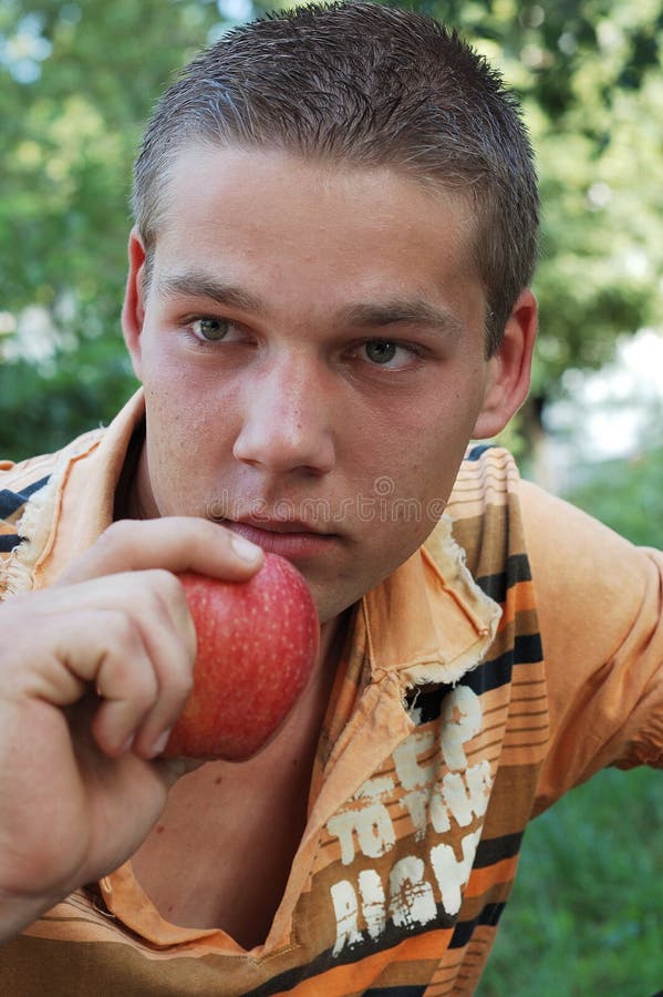 Young man with red apple stock photo. Image of appetizing - 5566182