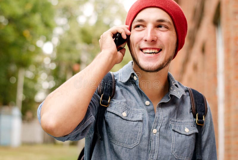 The Young Man with Red Cap Calls on His Cell Phone Stock Photo - Image ...