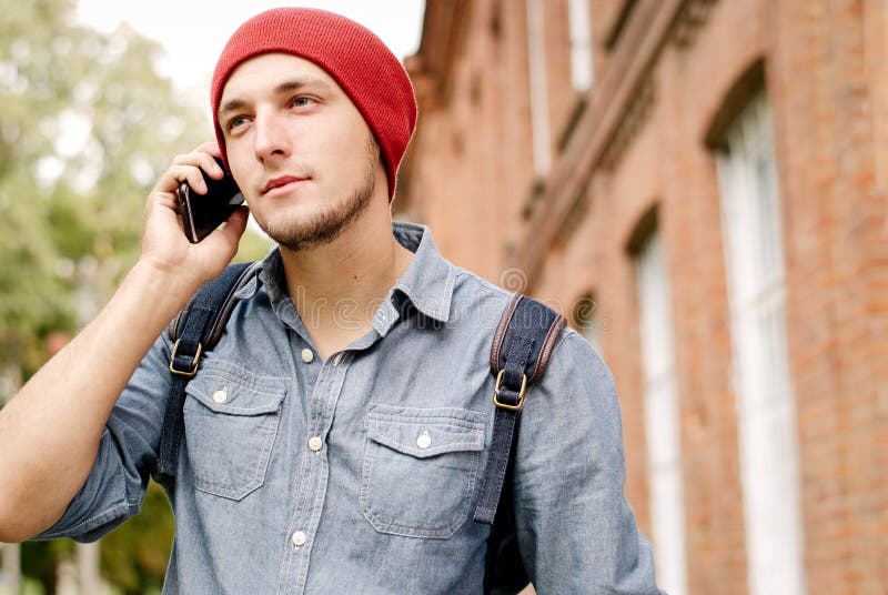The Young Man with Red Cap Calls on His Cell Phone Stock Photo - Image ...