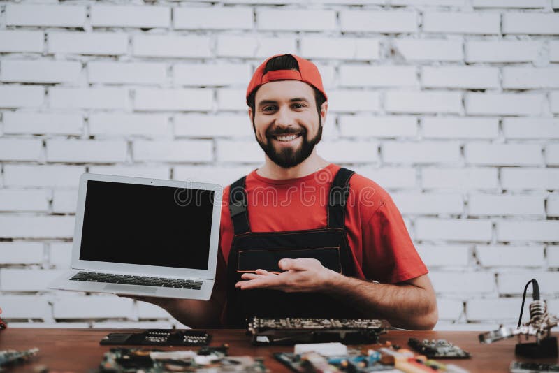 Young Man in Red Cap with Fixed Laptop in Workshop Stock Image - Image ...
