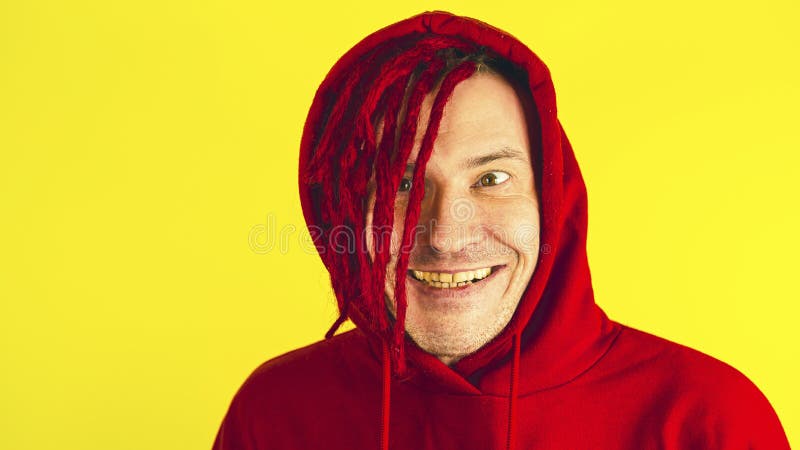 Young Man with Red Dreadlocks in Hood Grimacing Face. Crazy Guy Aping ...