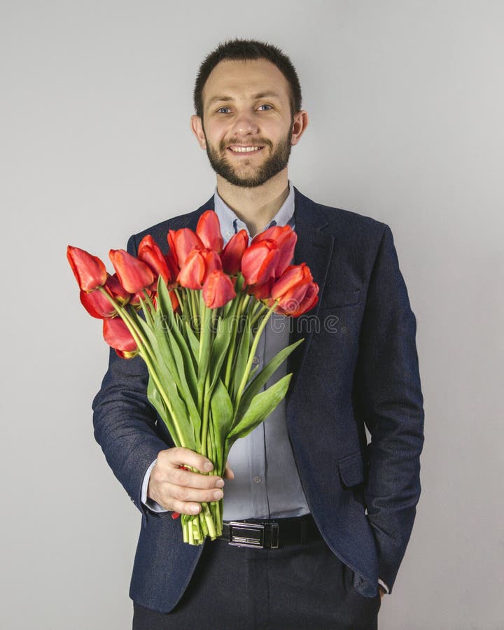 A Young Man with Red Flowers Stock Image - Image of flowers, making ...