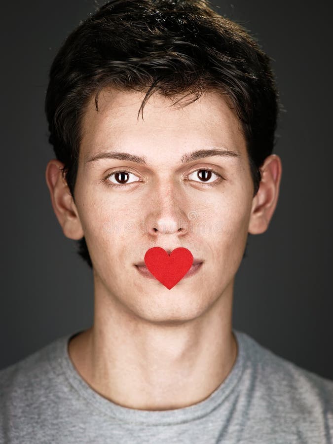 Young man with red heart stock photo. Image of closeup - 17995478