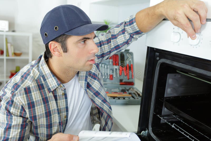 Young Man Regulating Temperature Broken Oven Stock Image - Image of ...