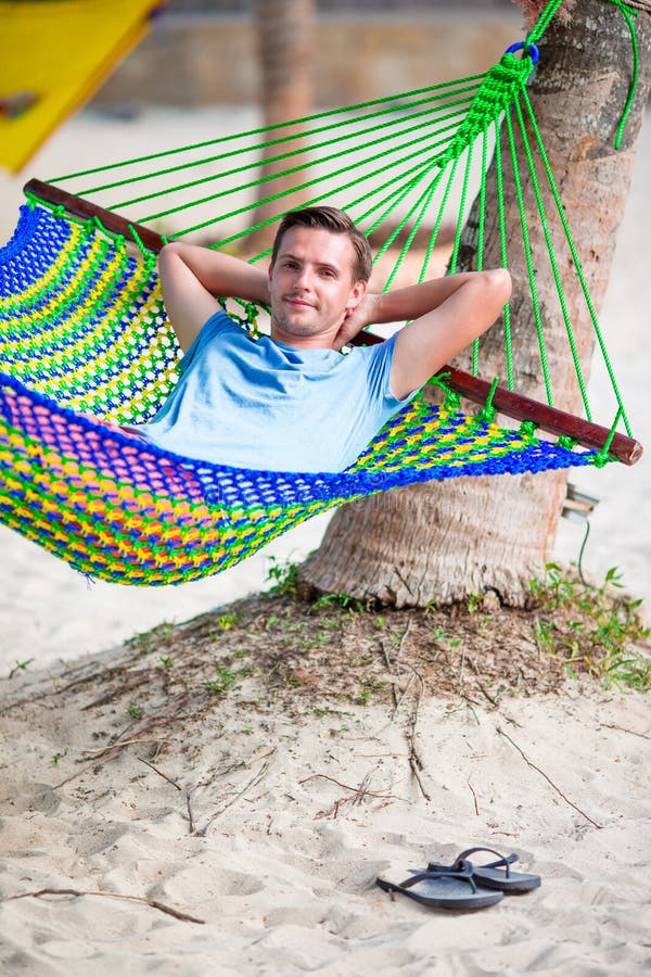 Young man relax in hammock stock image. Image of seashore - 70580247