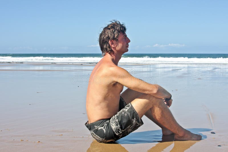 Young Man Relaxing on the Beach Stock Image - Image of beach, outside ...