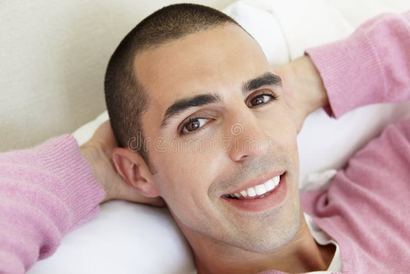 Young Man Relaxing on Bed stock photo. Image of twenties - 55892764