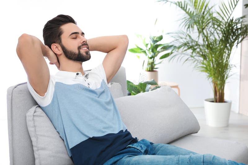 Young Man Relaxing on Couch at Home Stock Image - Image of comfortable ...