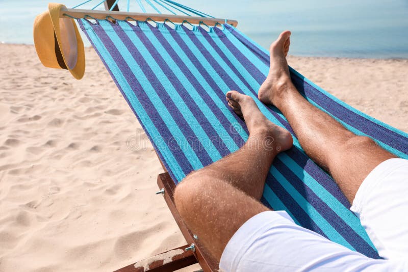 Young Man Relaxing in Hammock on Beach Stock Photo - Image of ...