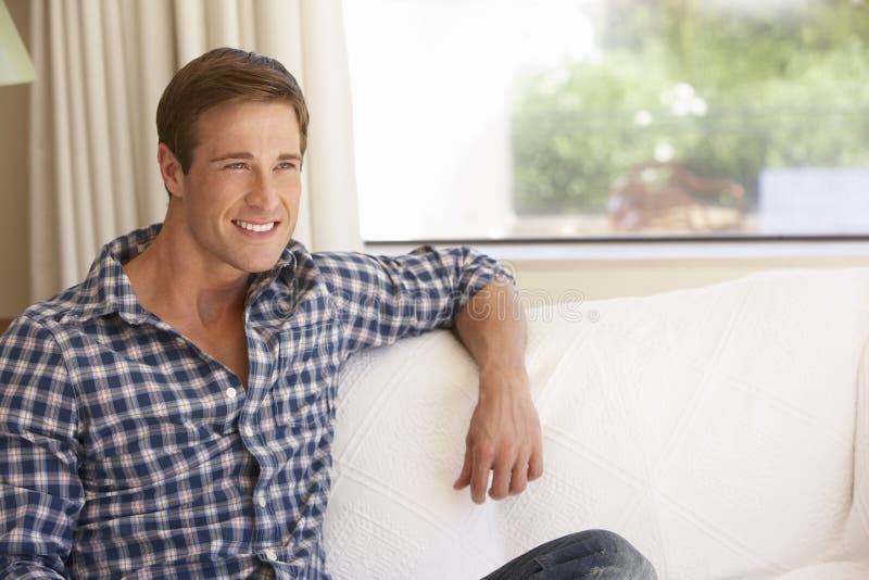 Young Man Relaxing at Home stock image. Image of relaxing - 54938593