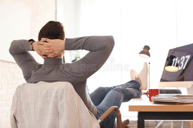 Young Man Relaxing in Office during Break Stock Photo - Image of ...