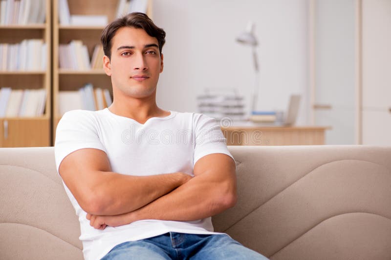 The Young Man Relaxing Sitting in Couch Sofa Stock Photo - Image of ...