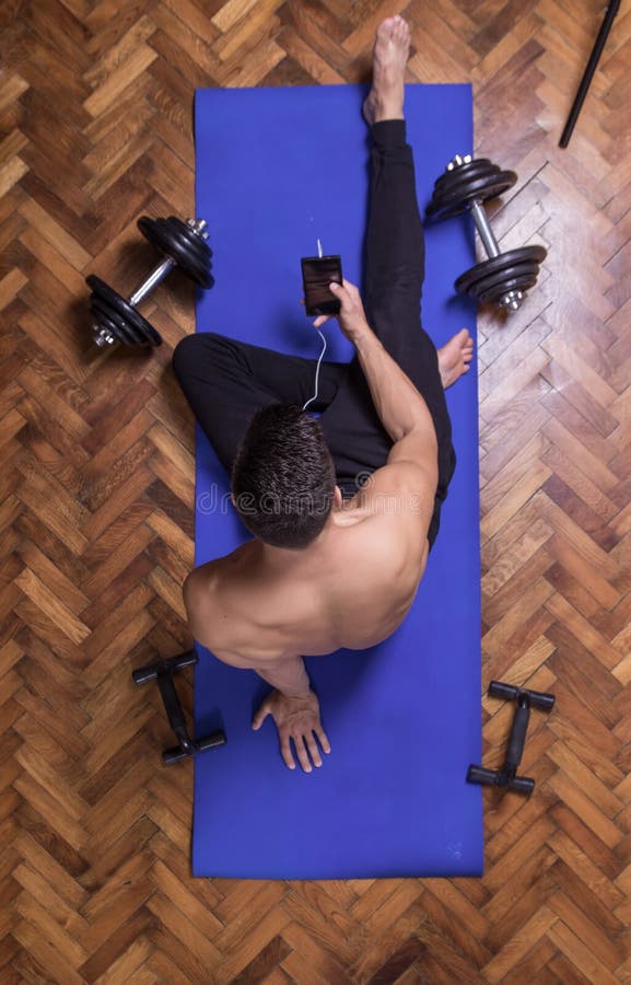 Young Man Relaxing Smartphone Elevated View Exercise Mat Stock Image ...