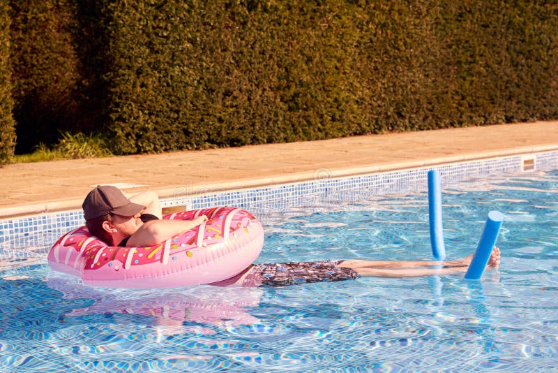 Young Man Relaxing on Summer Vacation Floating in Swimming Pool in ...