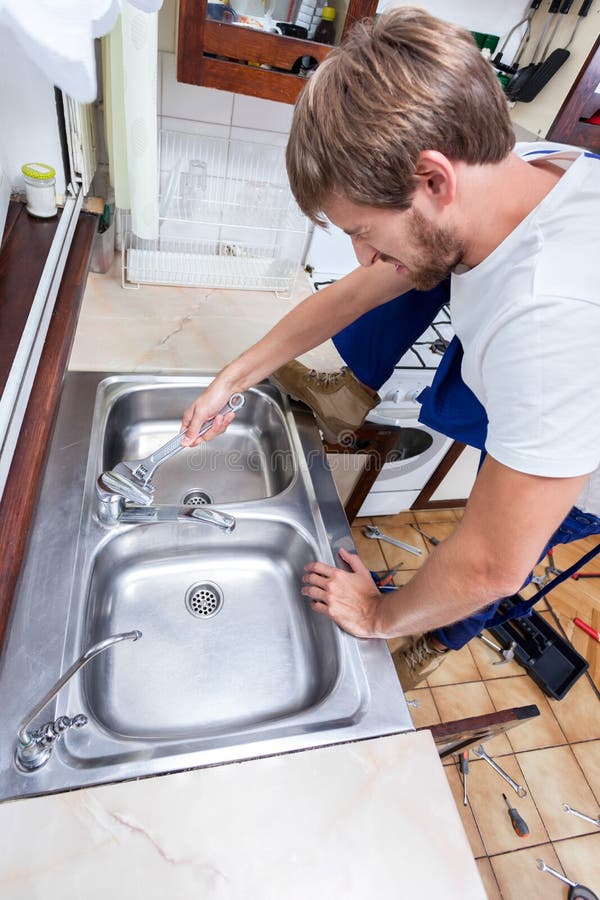 Young Man Repairing Kitchen Sink Stock Photo - Image of assistance ...