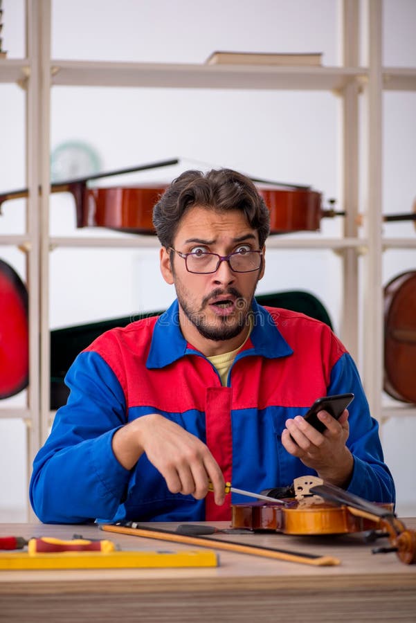 Young Man Repairing Musical Instruments at Workshop Stock Photo - Image ...