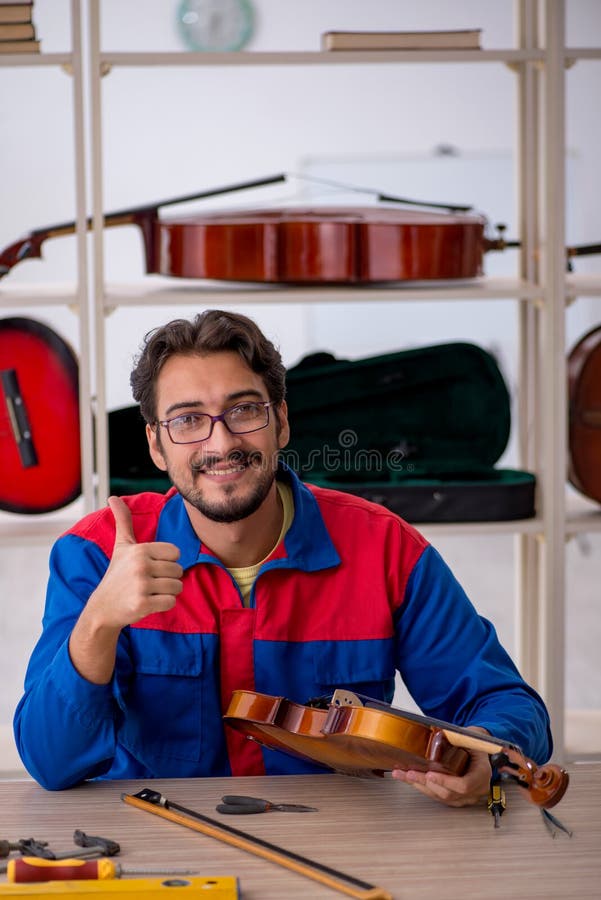 Young Man Repairing Musical Instruments at Workshop Stock Image - Image ...