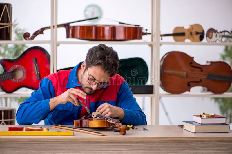 Young Man Repairing Musical Instruments at Workshop Stock Photo - Image ...