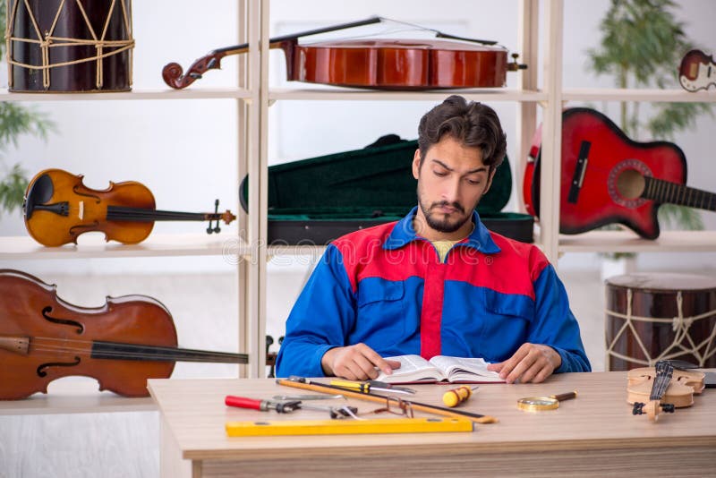Young Man Repairing Musical Instruments at Workshop Stock Image - Image ...