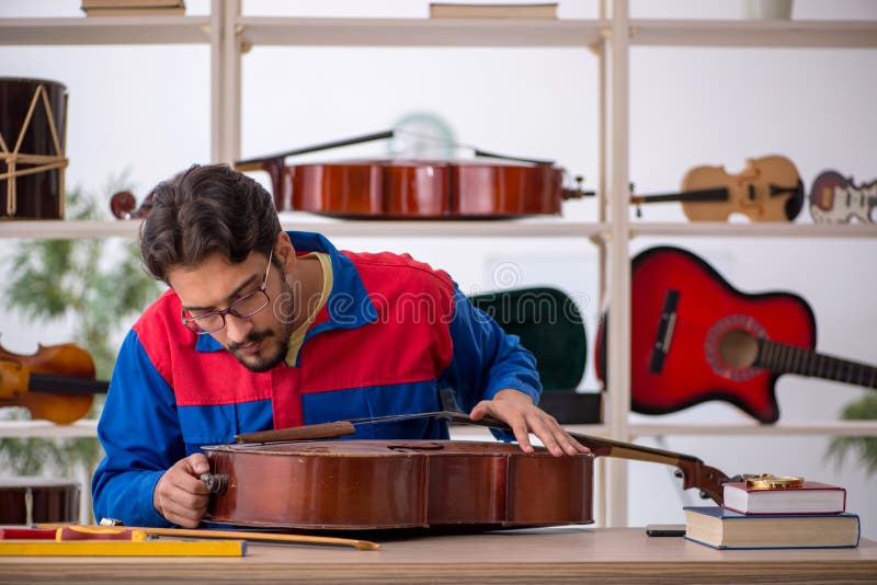 Young Man Repairing Musical Instruments at Workshop Stock Image - Image ...