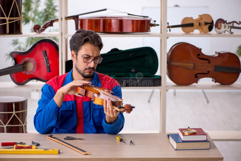 Young Man Repairing Musical Instruments at Workshop Stock Photo - Image ...