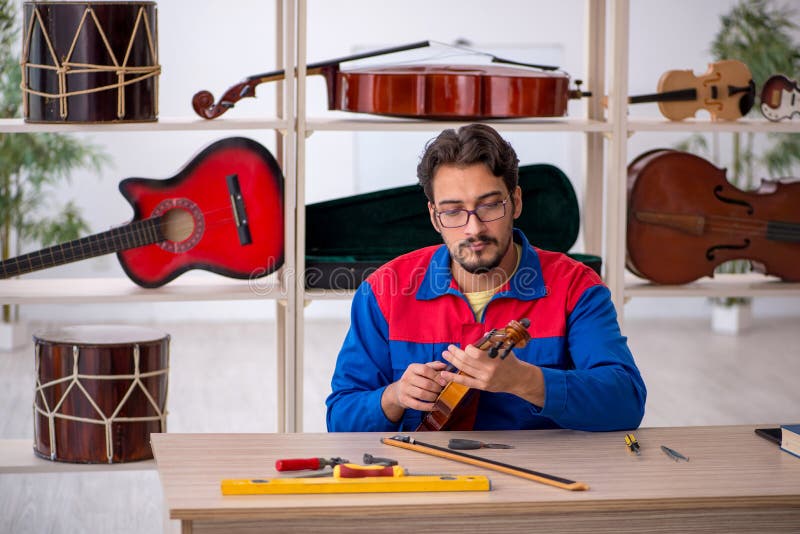 Young Man Repairing Musical Instruments at Workshop Stock Image - Image ...