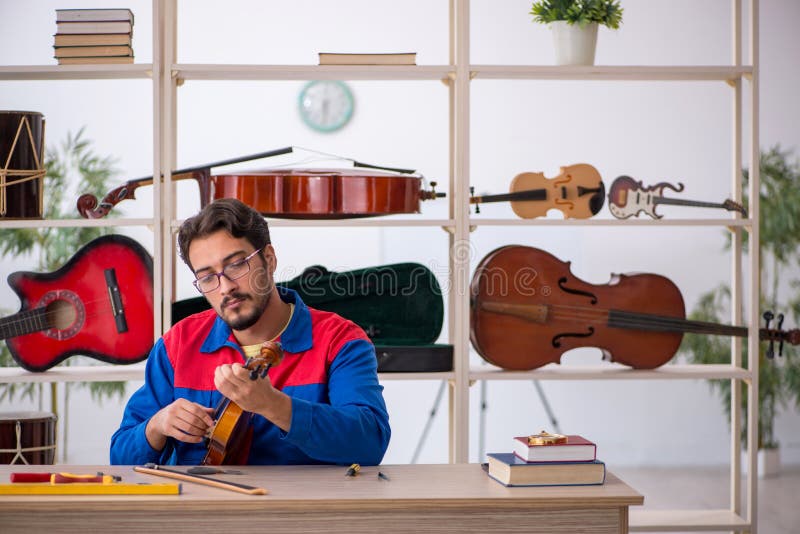 Young Man Repairing Musical Instruments at Workshop Stock Photo - Image ...