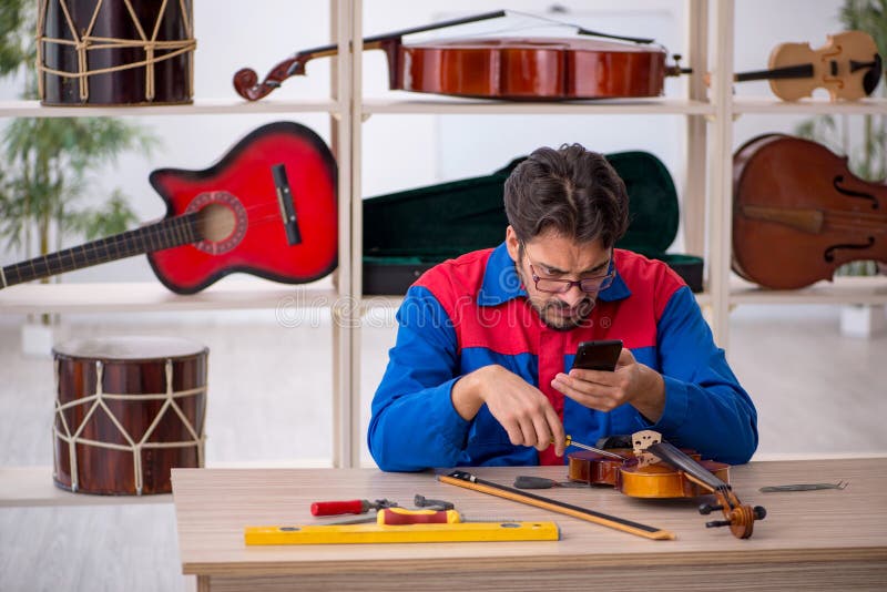 Young Man Repairing Musical Instruments at Workshop Stock Image - Image ...