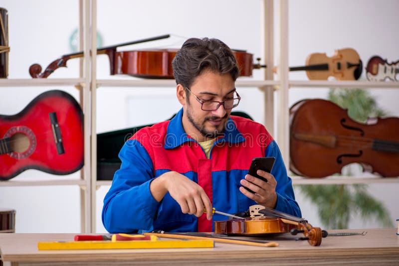 Young Man Repairing Musical Instruments at Workshop Stock Photo - Image ...