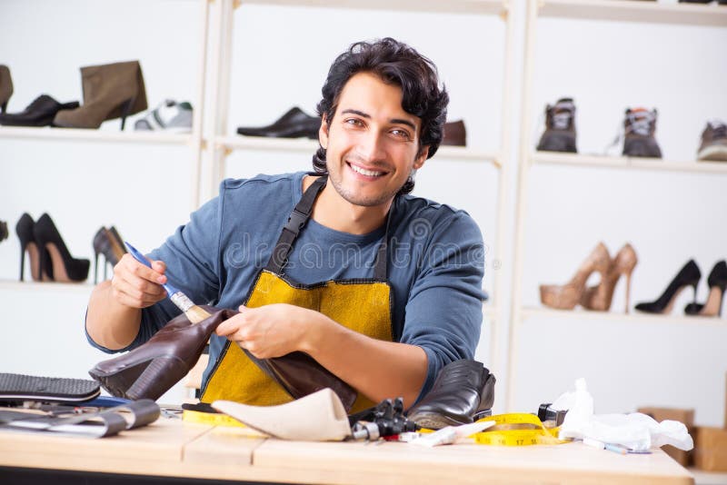 The Young Man Repairing Shoes in Workshop Stock Photo - Image of ...