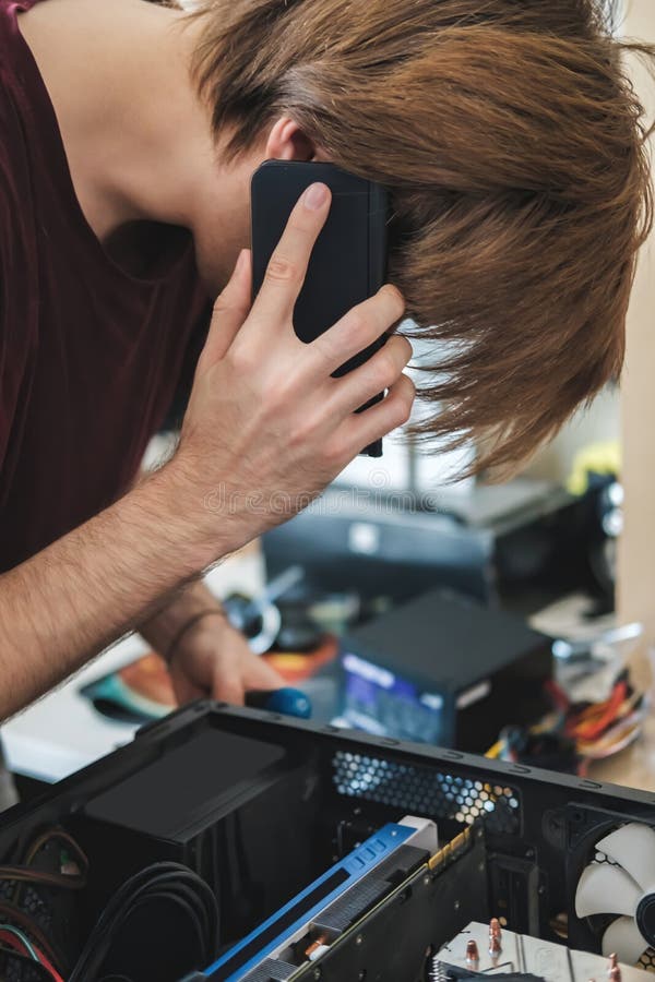 Young Man Repairs a Computer System Unit, Changes Parts, Video Card and ...