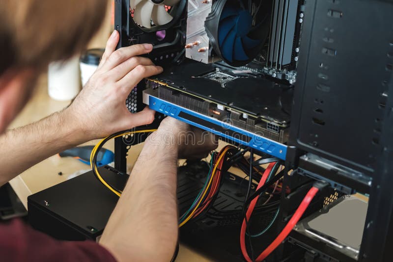 Young Man Repairs a Computer System Unit, Changes Parts, Video Card and ...