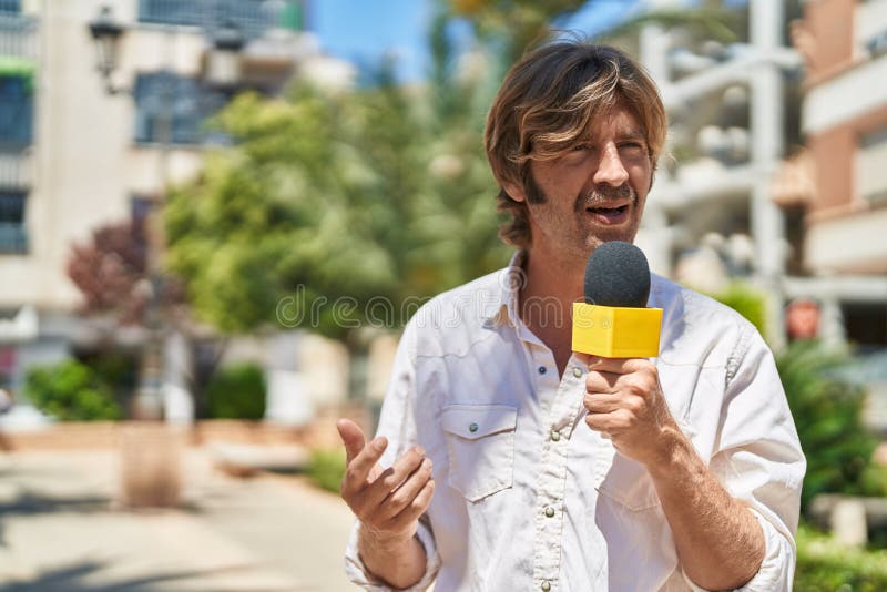 Young Man Reporter Working Using Microphone at Park Stock Photo - Image ...