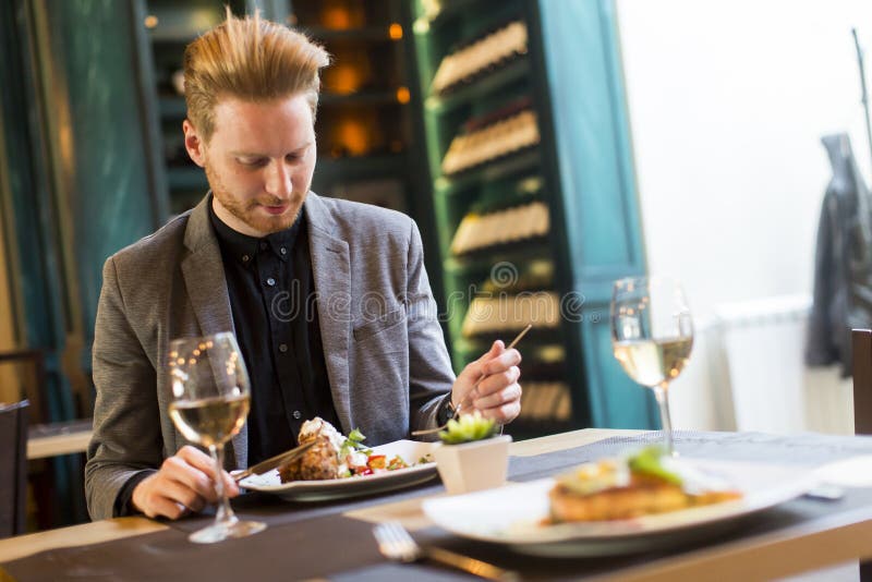 Young man in restaurant stock image. Image of healthy - 76855833