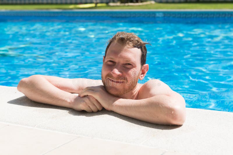 Young Man Resting on Edge of Swimming Pool Stock Photo - Image of hair ...