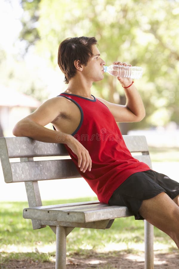 Young Man Resting after Exercise in Park Stock Image - Image of ...