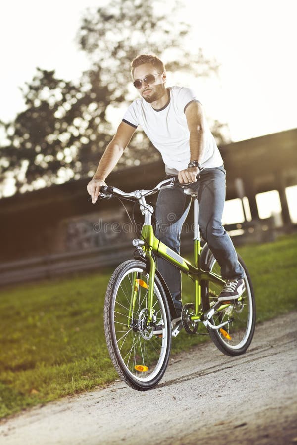 Young man riding bicycle stock photo. Image of concept - 27322572