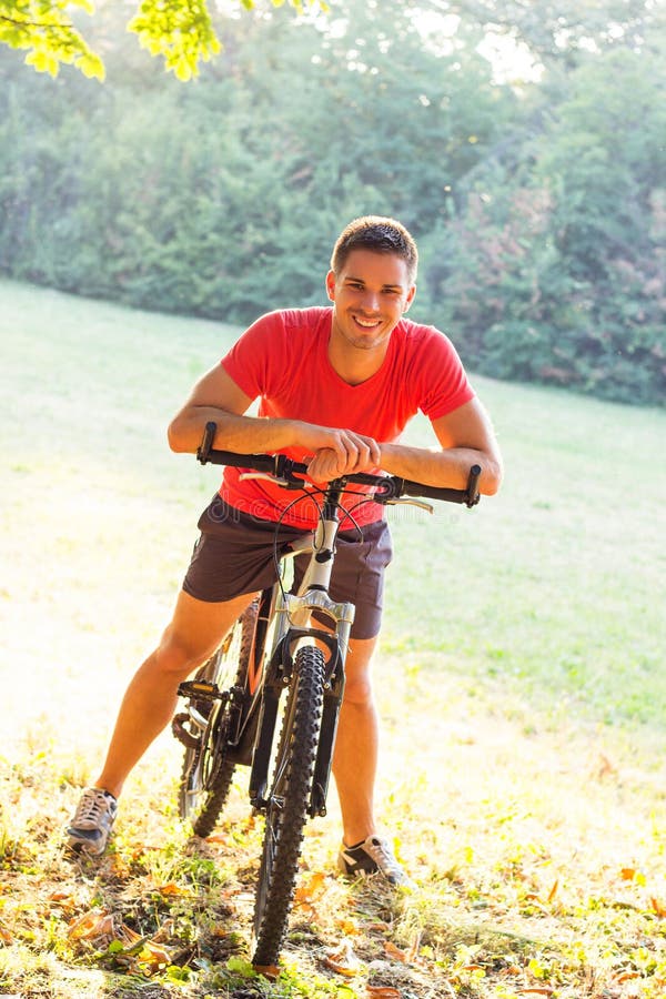 Young man riding bicycle stock image. Image of adult - 36024467